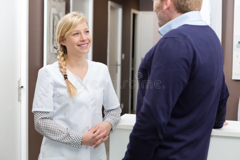 Friendly Receptionist at Work Stock Photo - Image of female, male ...