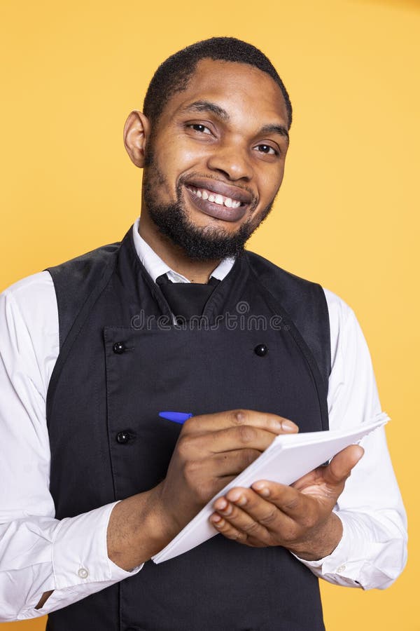 Friendly Restaurant Waiter Taking Notes of Meal Orders for Clients ...