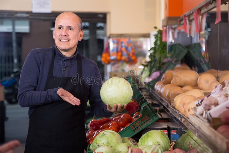 Friendly Salesman with Zucchini in Vegetable Shop Stock Image - Image ...