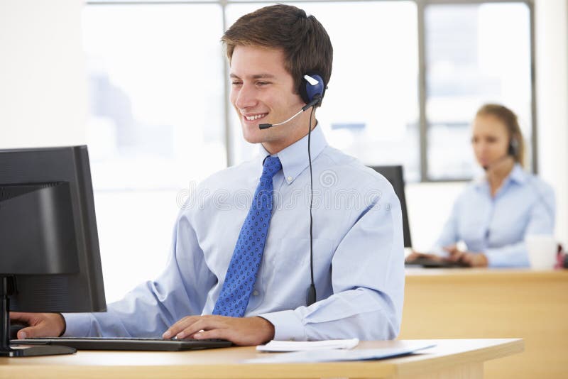 Friendly Service Agent Talking To Customer in Call Centre Stock Image ...