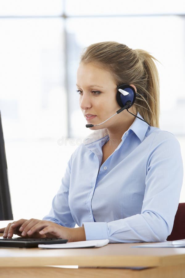 Friendly Service Agent Talking To Customer in Call Centre Stock Image ...