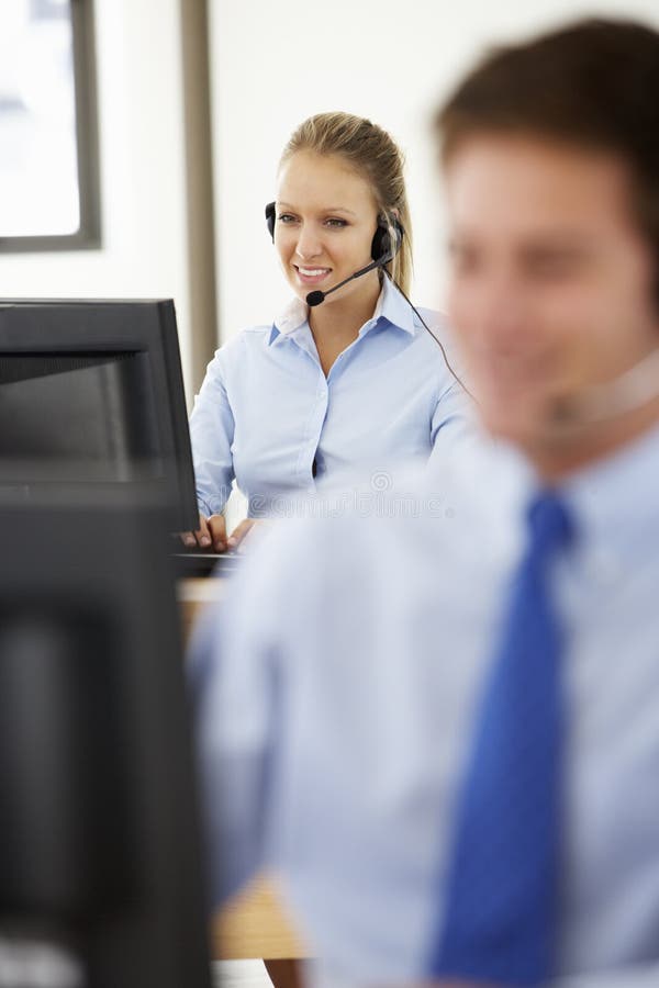 Friendly Service Agent Talking To Customer in Call Centre Stock Image ...