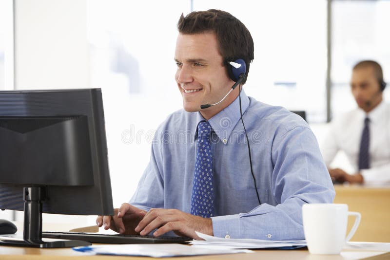 Friendly Service Agent Talking To Customer in Call Centre Stock Photo ...