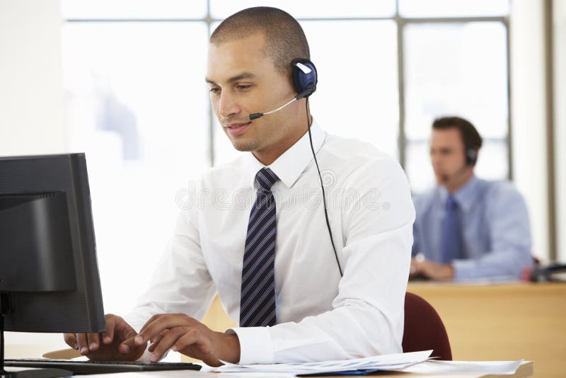 Friendly Service Agent Talking To Customer in Call Centre Stock Photo ...