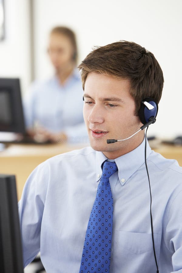 Friendly Service Agent Talking To Customer in Call Centre Stock Image ...