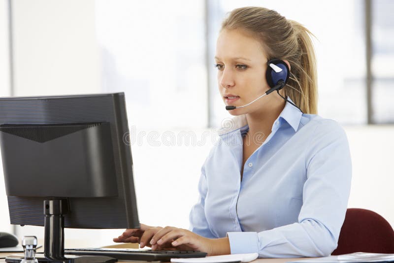 Friendly Service Agent Talking To Customer in Call Centre Stock Image ...