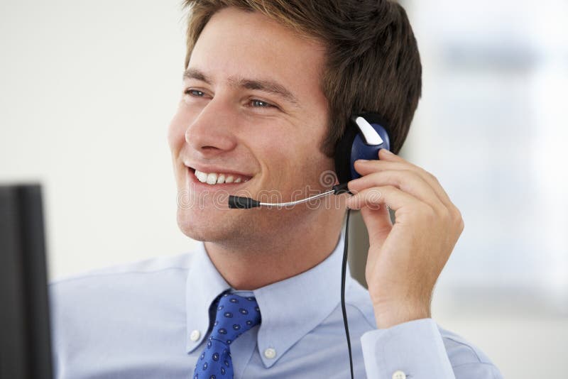 Friendly Service Agent Talking To Customer in Call Centre Stock Image ...