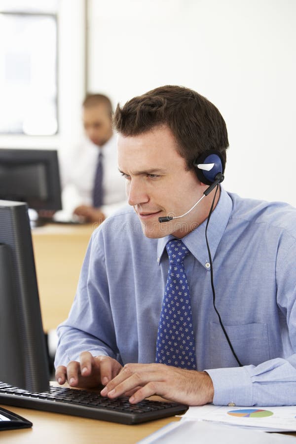 Friendly Service Agent Talking To Customer in Call Centre Stock Image ...