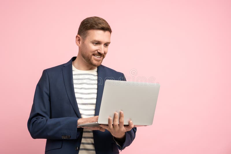 Smiling Relaxed Middle-aged Man in Office Look Holding Laptop Computer ...
