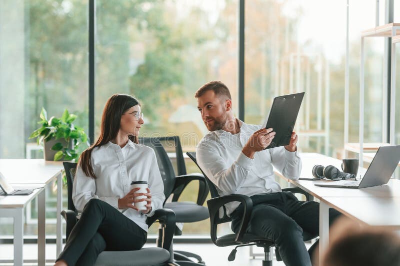 Friendly Talking. Man and Woman are Working in the Modern Office ...