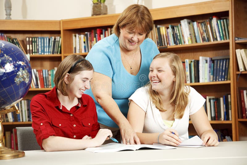 Friendly Teacher Helping Students Stock Photo - Image of notebook ...