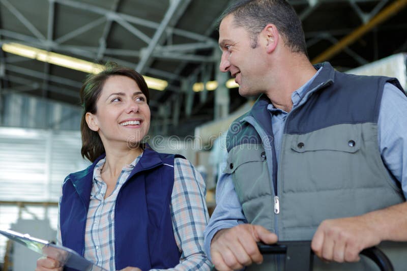 Friendly Warehouse Workers Smiling at Each Other Stock Photo - Image of stores, colleague: 277099736