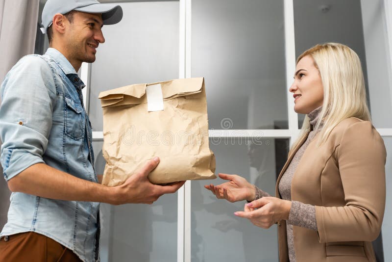 Friendly Young Delivery Man Delivering a Package Stock Image - Image of ...