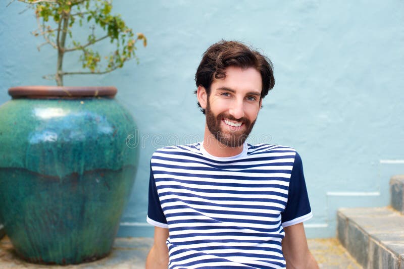 Friendly Young Man Sitting and Smiling Stock Photo - Image of male ...