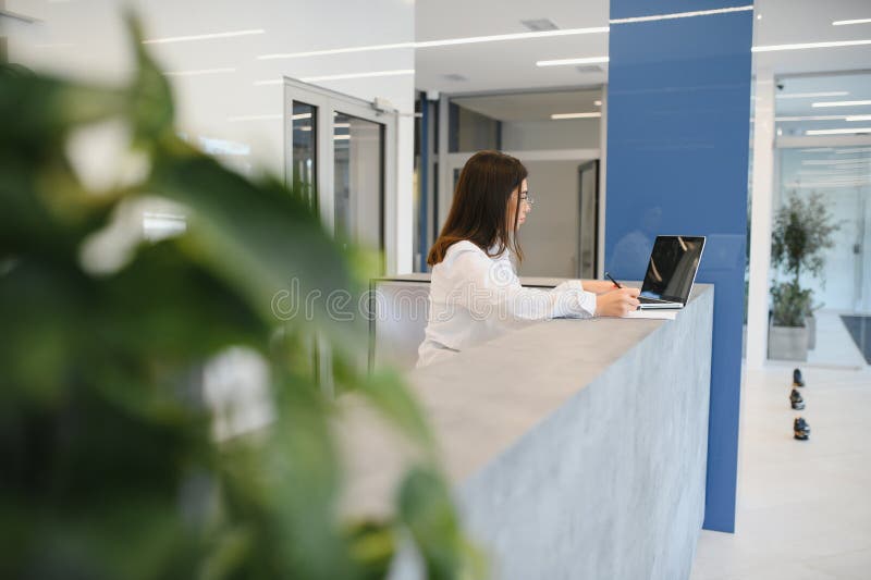 Friendly Young Woman Behind the Reception Desk Administrator Stock ...