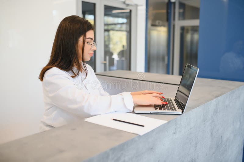 Friendly Young Woman Behind the Reception Desk Administrator Stock ...