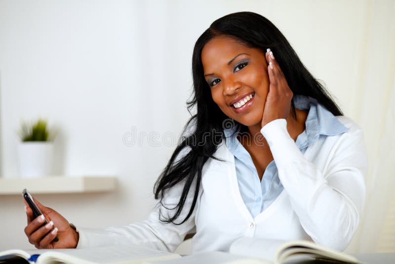 Friendly Young Woman Looking To You with Cellphone Stock Photo - Image ...