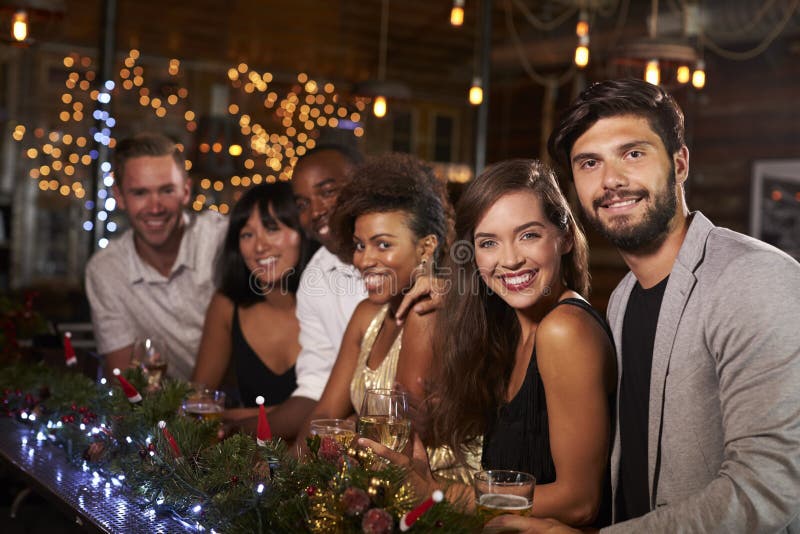 Friends at the Bar during a Christmas Party Look To Camera Stock Image ...