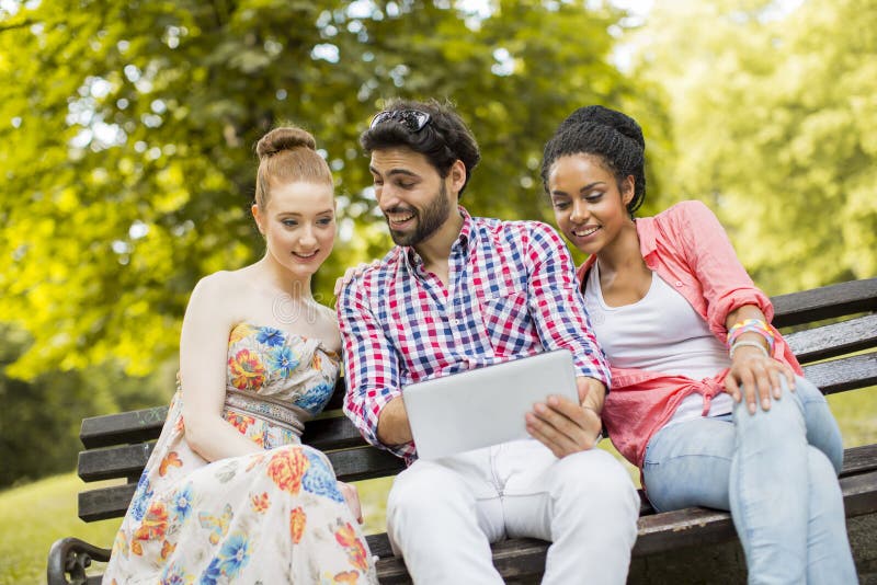 Friends on the Bench with Tablet Stock Image - Image of adult, female ...