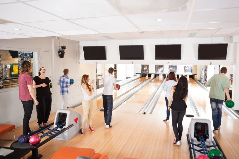 Friends Bowling in Club stock image. Image of indoor - 37103741