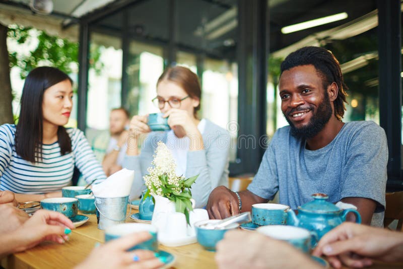 Friends in cafe stock photo. Image of young, intercultural - 74547634