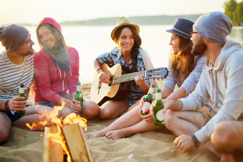 Friends by camp fire stock photo. Image of guitar, together - 67249400