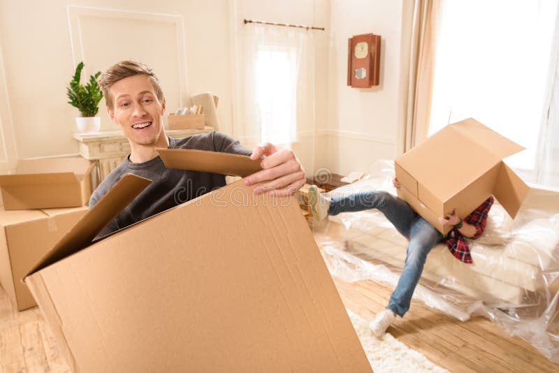 Friends with Cardboard Boxes Moving into New House Stock Image - Image ...