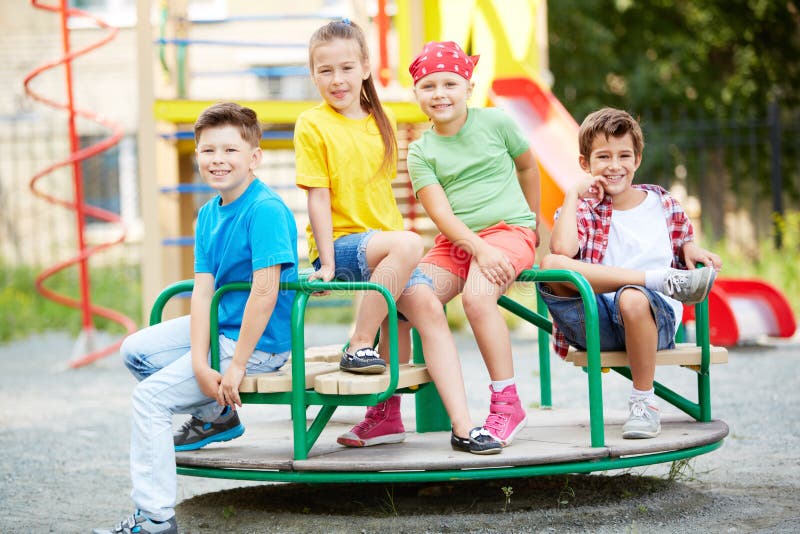 Children Sit on Playground Carousel with Springs Stock Photo - Image of ...