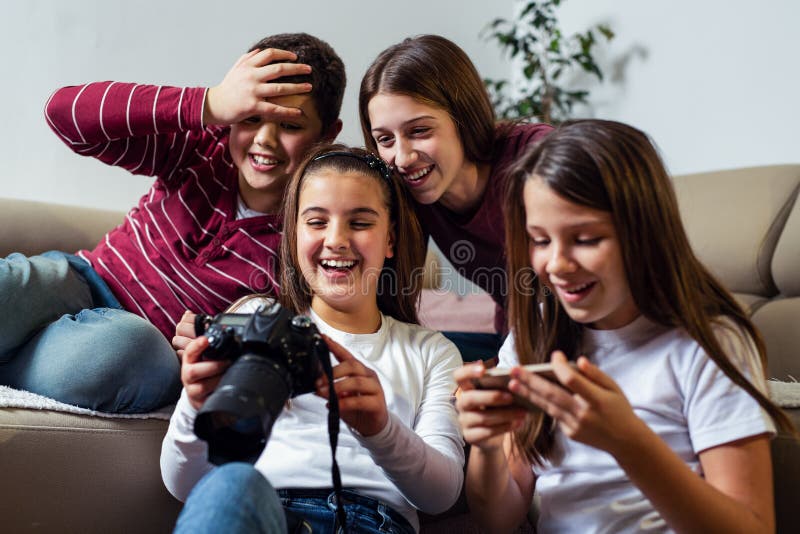 Friends Checking Photos on a Camera Stock Image - Image of photographic ...