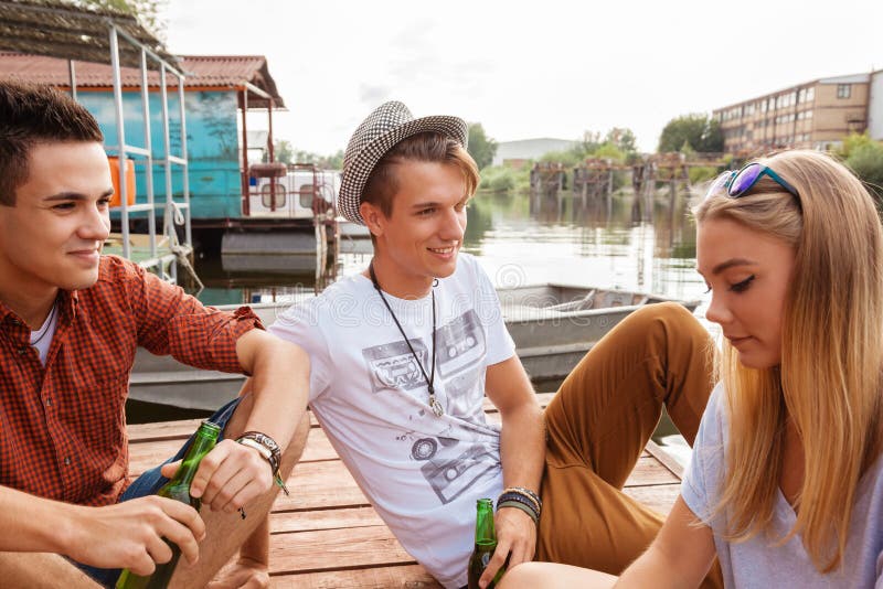 Friends Chilling Near Lake stock image. Image of friendship - 45194363