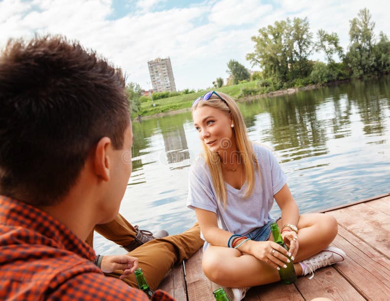 Friends Chilling Near Lake stock photo. Image of fashionable - 45194418