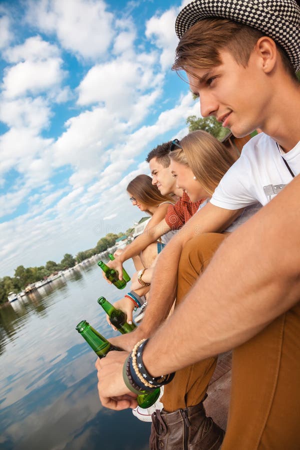 Friends Chilling Near Lake stock image. Image of female - 45194451