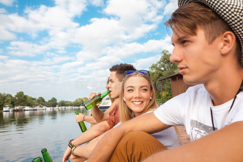 Friends Chilling Near Lake stock photo. Image of female - 45194488
