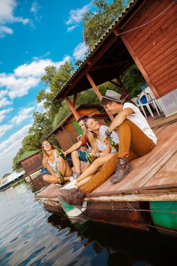 Friends Chilling Near Lake stock image. Image of enjoyment - 45195101