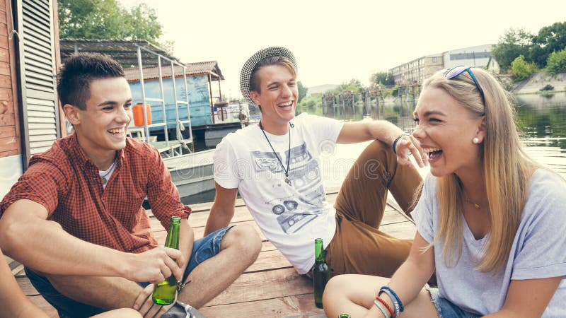 Friends Chilling Near Lake stock photo. Image of female - 78981220