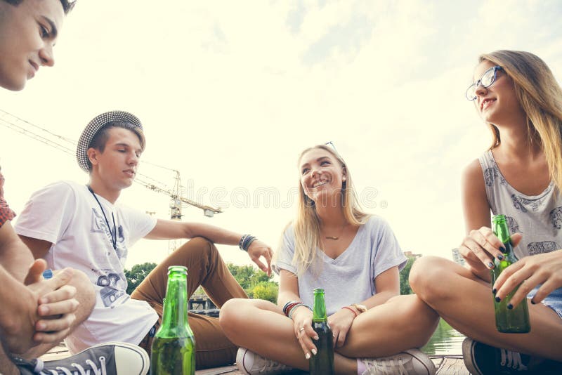 Friends Chilling Near Lake stock photo. Image of happiness - 78981972