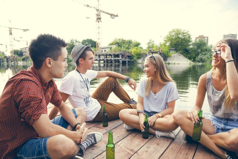 Friends Chilling Near Lake stock image. Image of female - 78982153