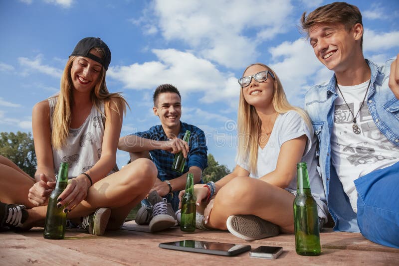 Friends Chilling Near Lake stock image. Image of female - 78982599