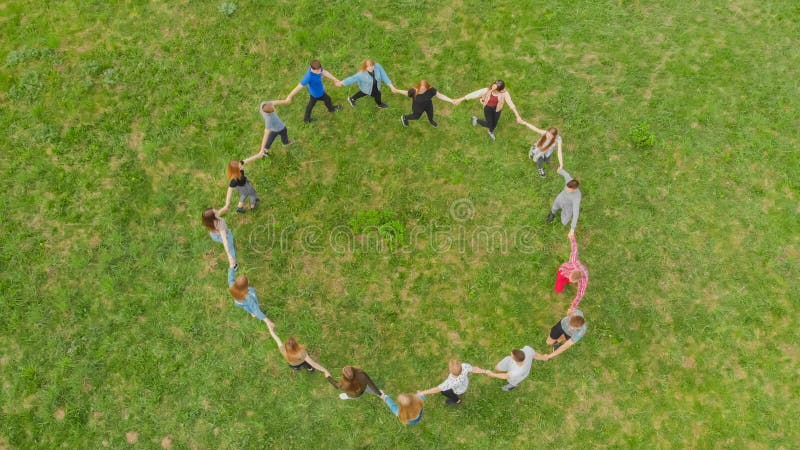 Friends in a Circle Holding Hands Make a Round Dance in the Field ...