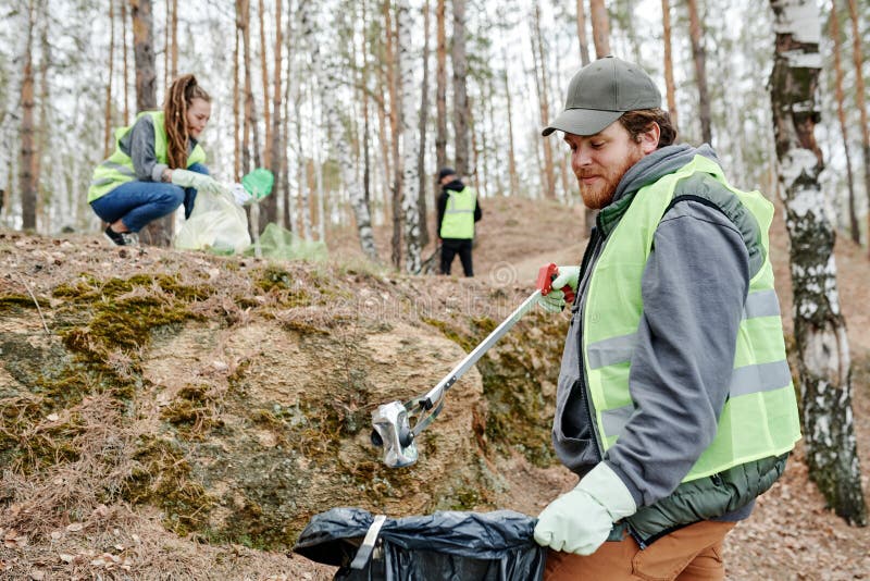Friends Collecting Garbage stock photo. Image of awareness - 268525106