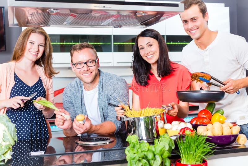 Friends Cooking Pasta and Meat in Domestic Kitchen Stock Photo - Image ...