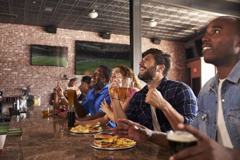 Friends at Counter in Sports Bar Watching Game Stock Image - Image of ...