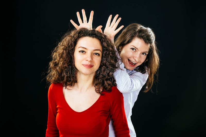 Friends Making Faces at Studio Stock Image - Image of serene, faces ...