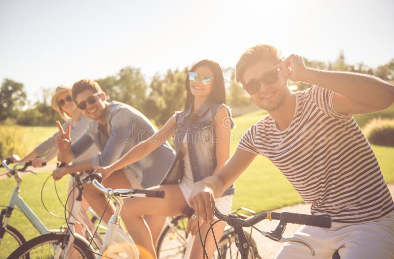 Friends cycling in park stock image. Image of beauty - 78205457