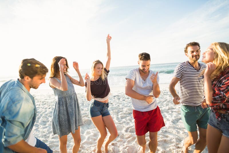 Friends Dancing on the Beach Stock Photo - Image of smiling, group ...