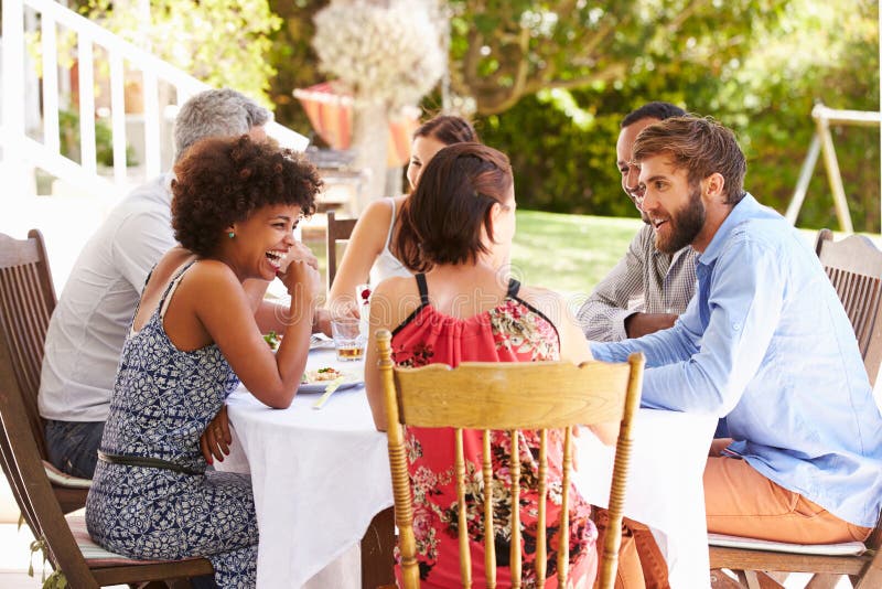 Friends Dining Together at a Table in a Garden Stock Photo - Image of ...