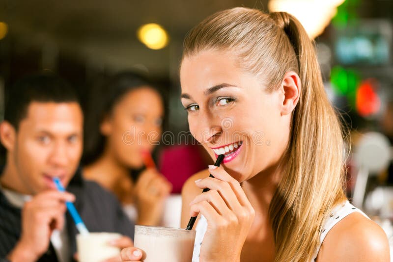 Friends Drinking Milkshakes in a Bar Stock Photo - Image of drink ...