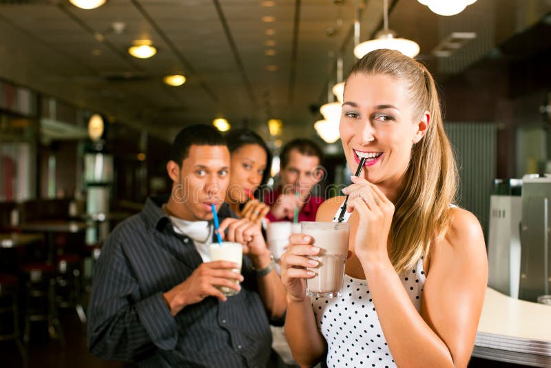 Friends Drinking Milkshakes in a Bar Stock Photo - Image of beautiful ...