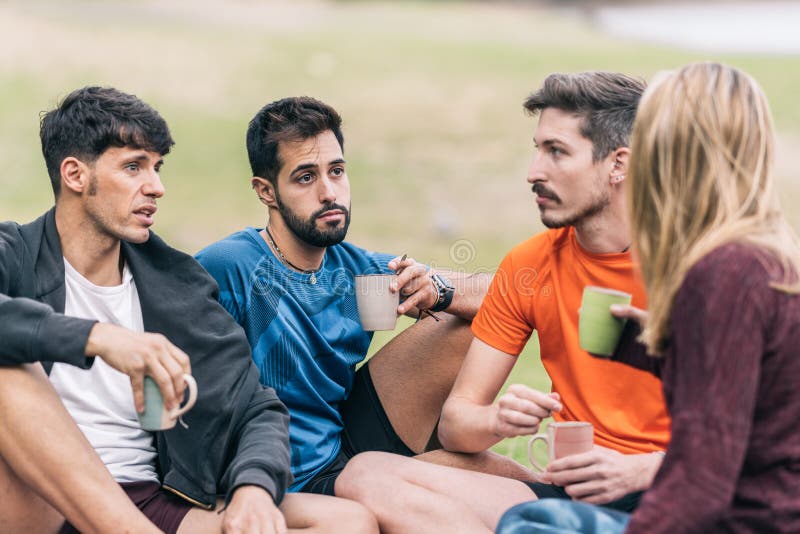 Friends Drinking Tea and Chat with Relaxed Expression Sitting on a Park ...