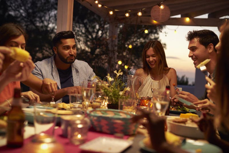 Friends Eat and Talk at a Dinner Party on a Patio, Close Up Stock Photo ...
